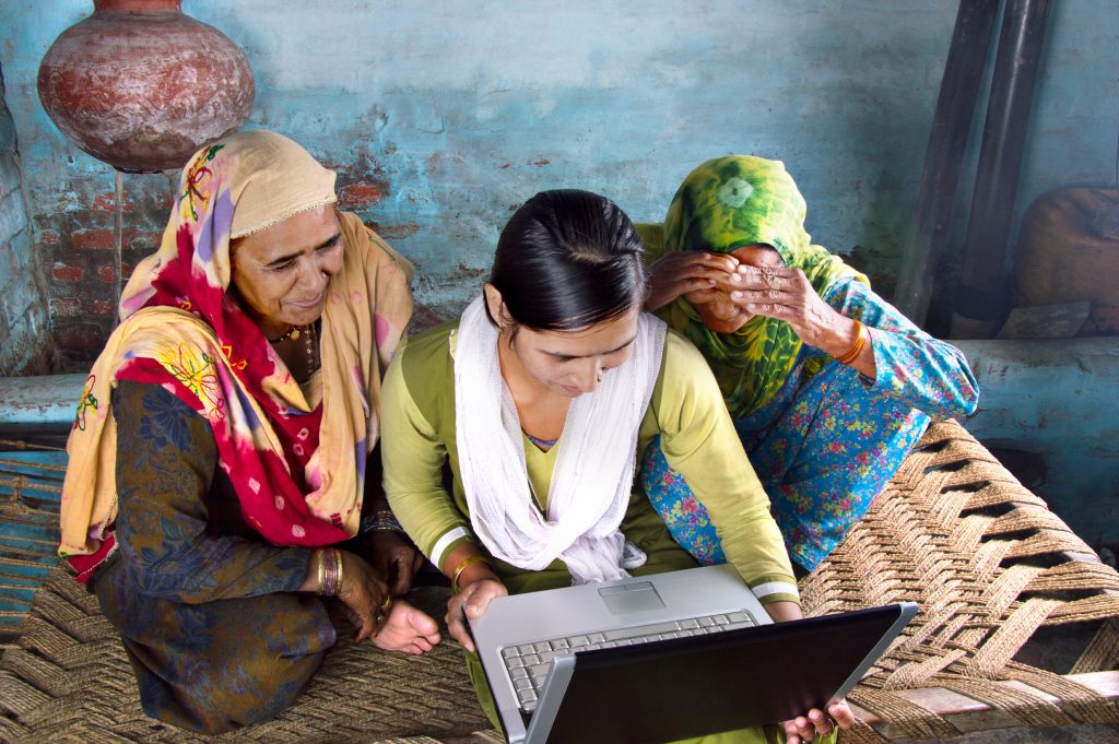 Mother and Daughter Holding Laptop at Home - Global Development ...
